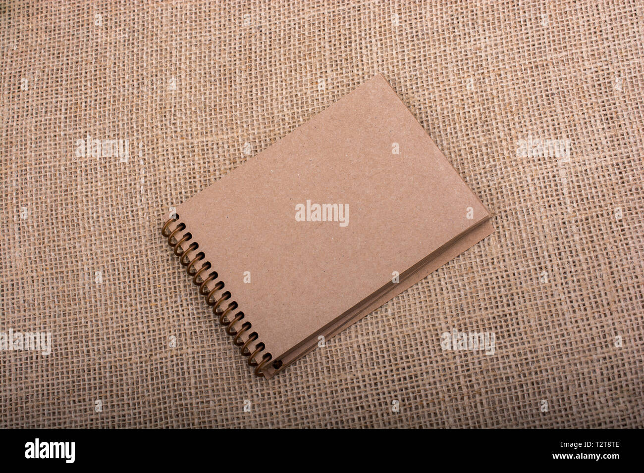 brown color notebook placed on a canvas background Stock Photo - Alamy