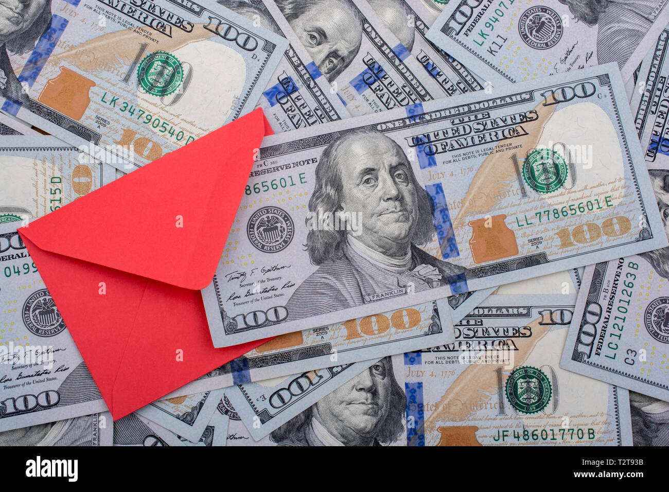 Little red envelope is placed on spread US dollar Banknotes Stock Photo ...