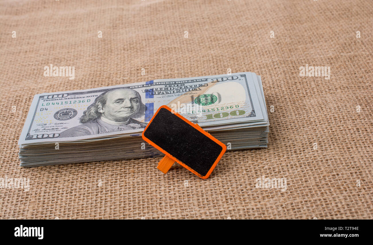Notice board placed on the bundle of US dollar banknote Stock Photo - Alamy