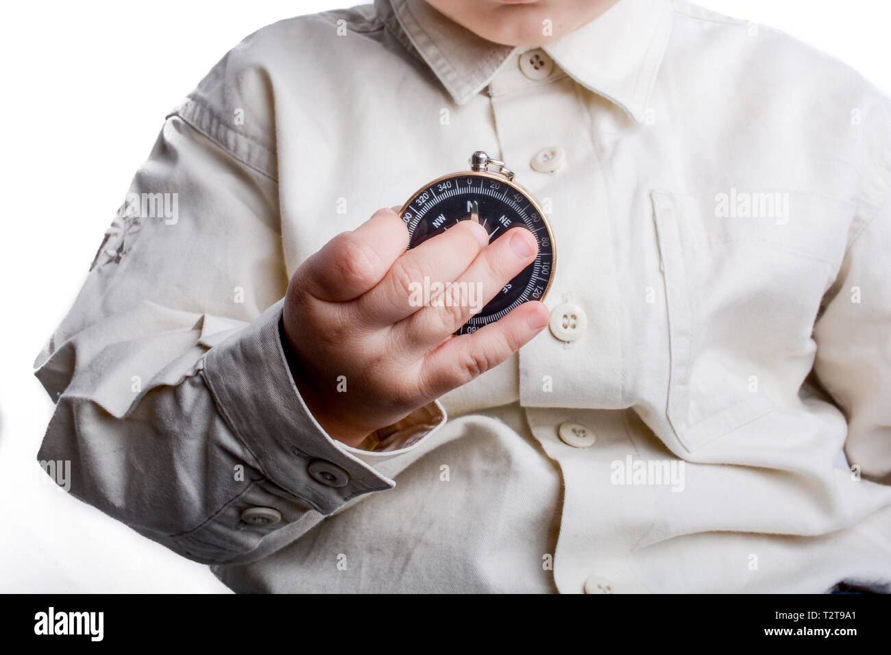 Isolated compass in baby's hand on a white background Stock Photo - Alamy