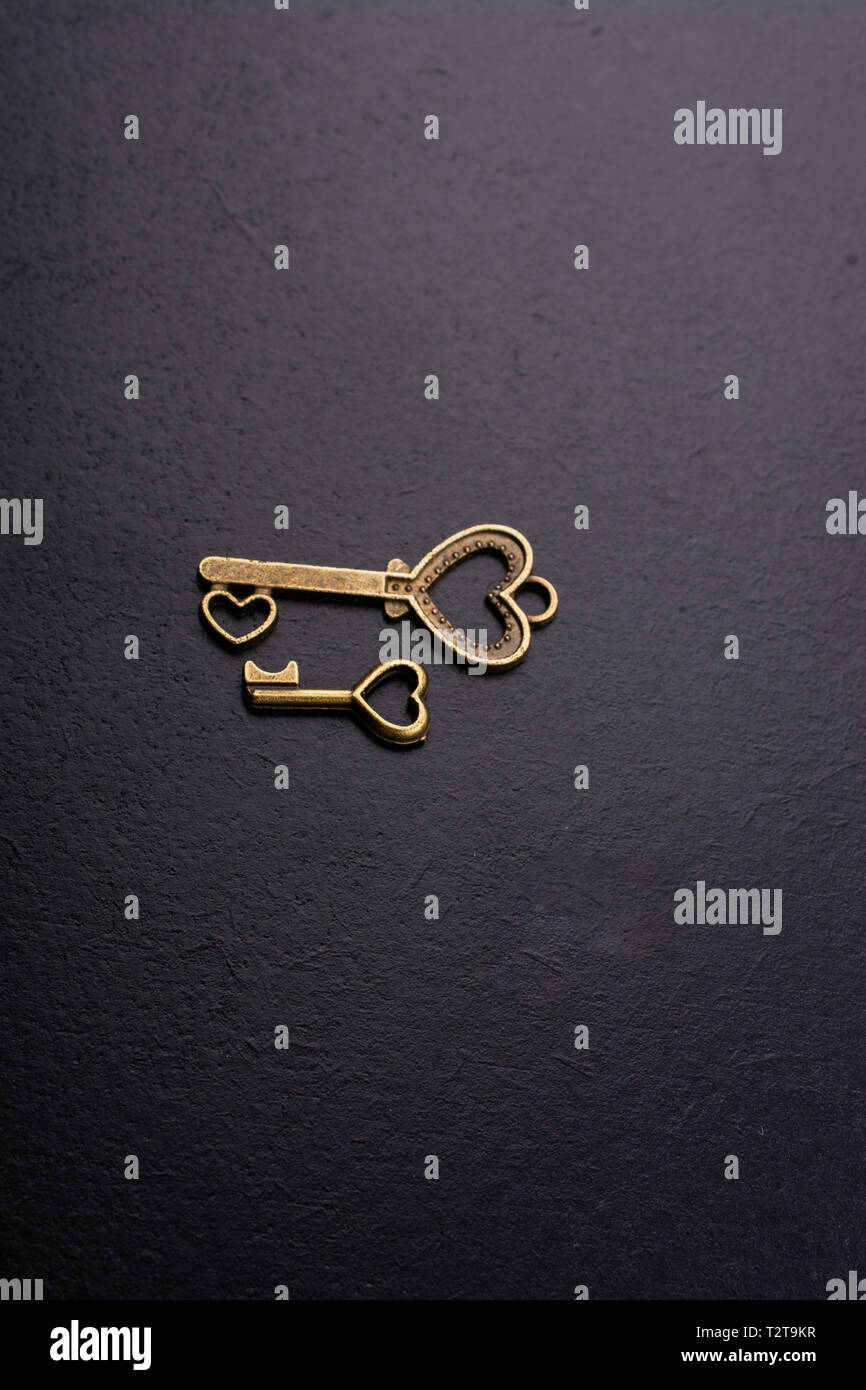 Heart shaped retro metal keys on dark background Stock Photo - Alamy