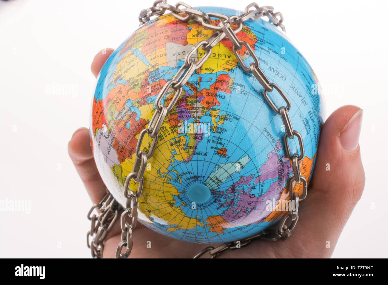 Globe in chain on a white background Stock Photo - Alamy