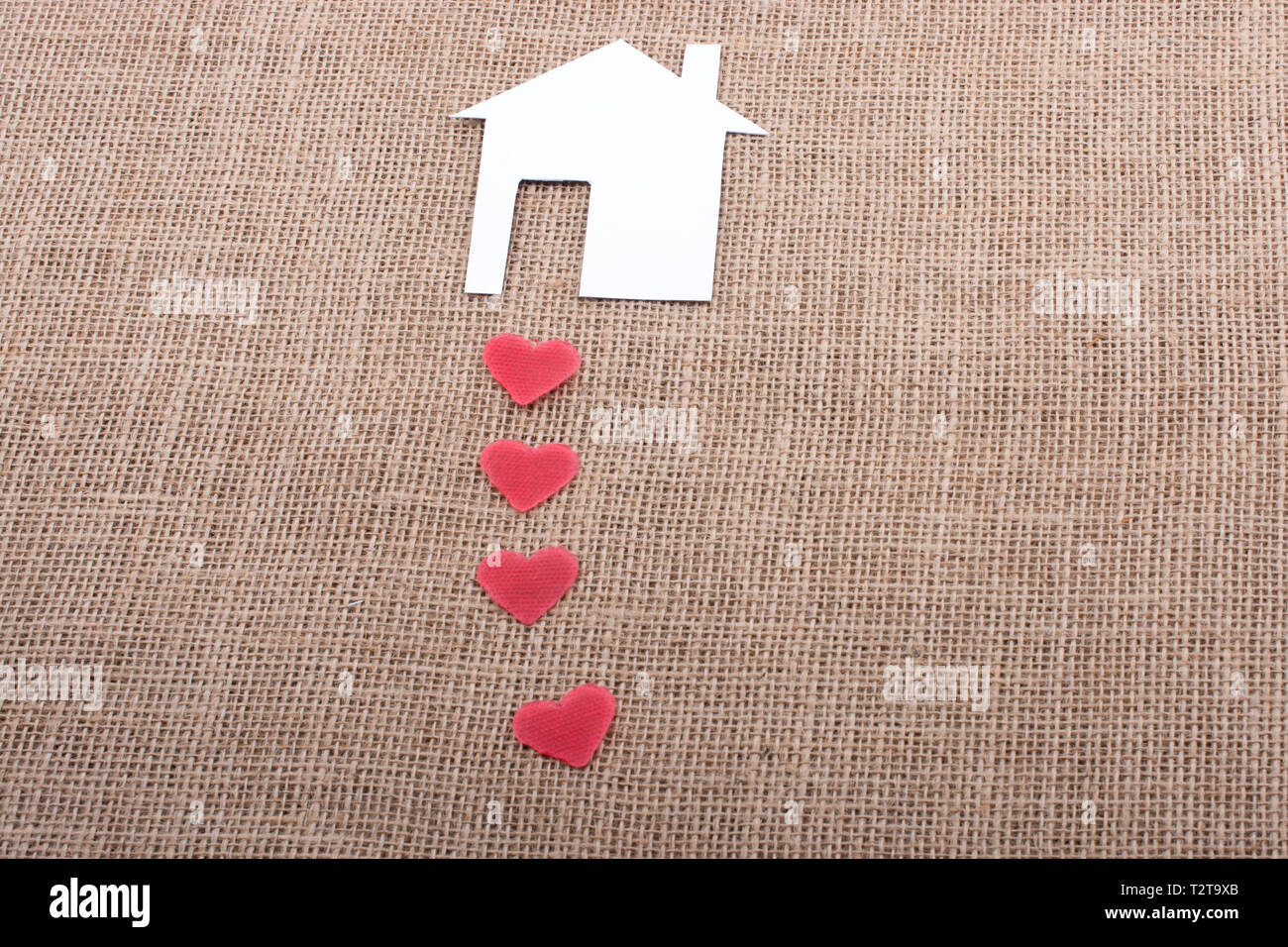 Model house and a heart shape beside it Stock Photo - Alamy