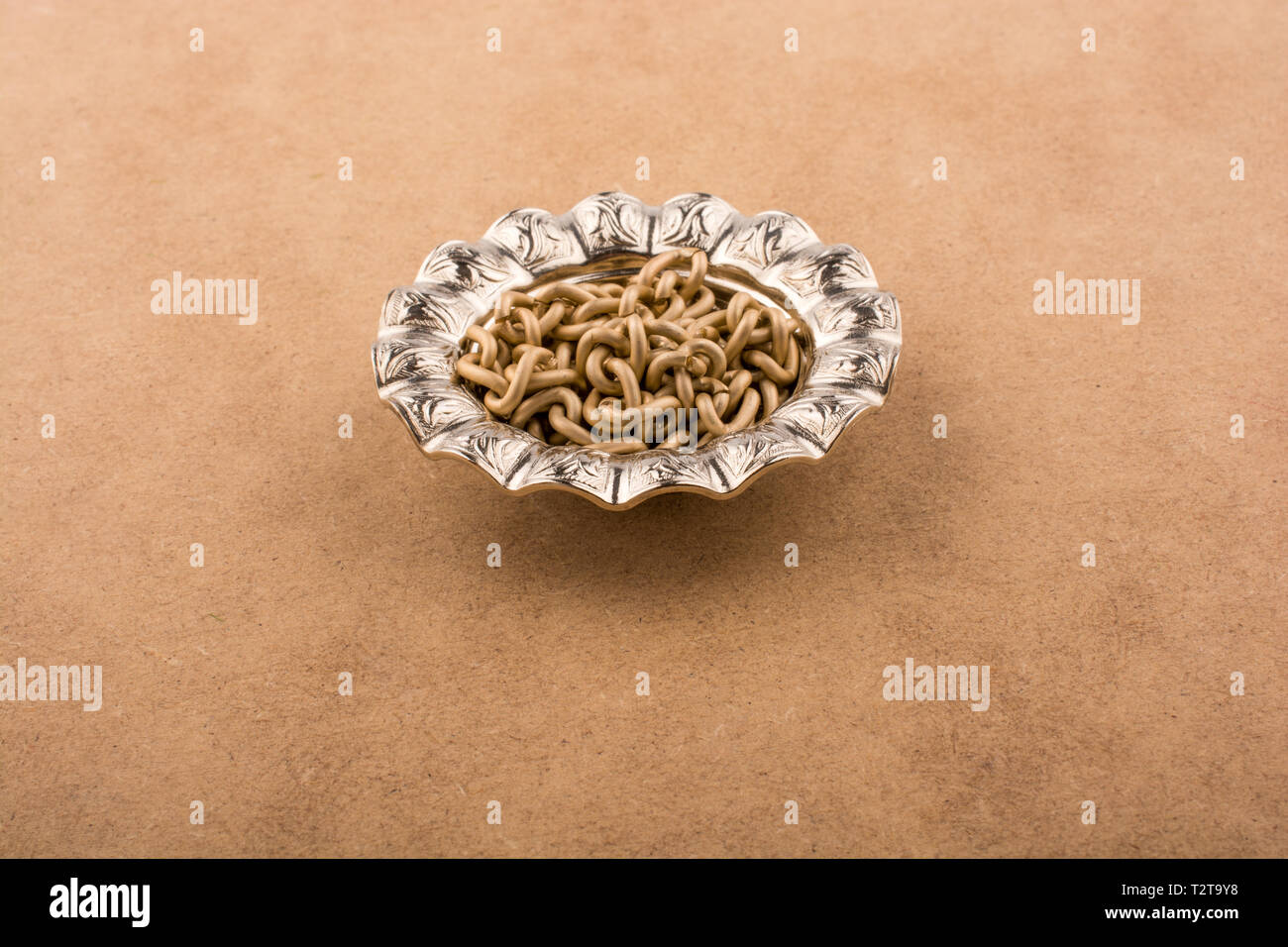 Fake gold coins in an old decorative metal plate Stock Photo - Alamy