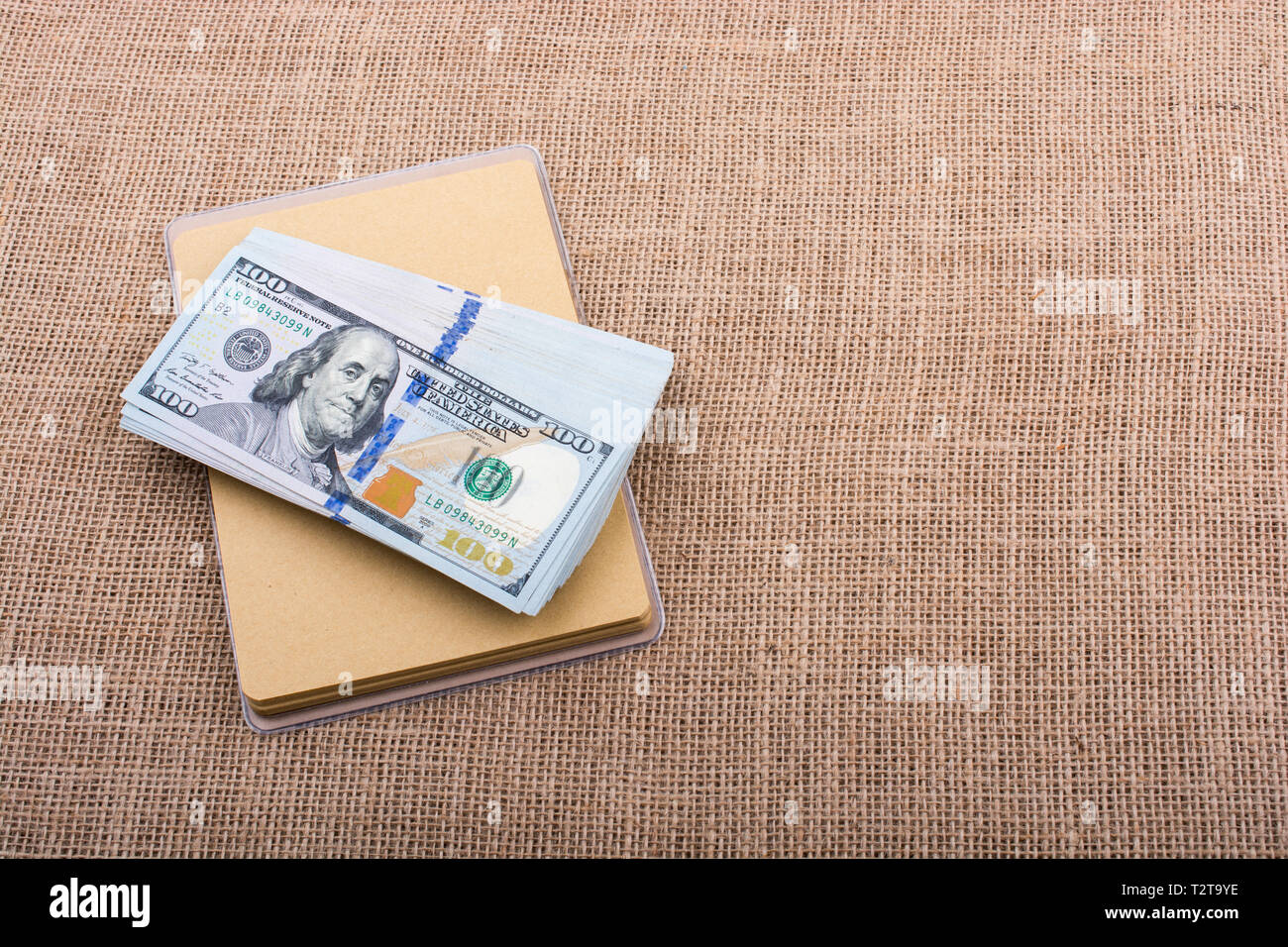 Banknote bundle of US dollar placed on a linen canvas Stock Photo - Alamy