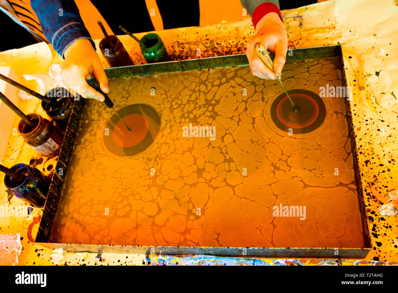 Hand drawing with stick stained inks on water surface Stock Photo - Alamy