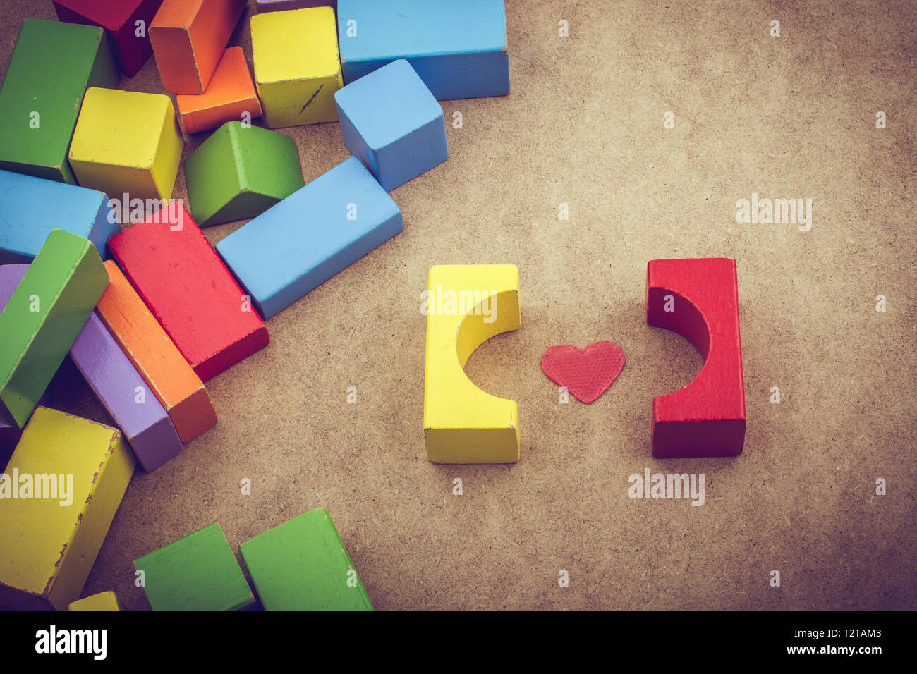 Heart shape placed between building blocks Stock Photo - Alamy