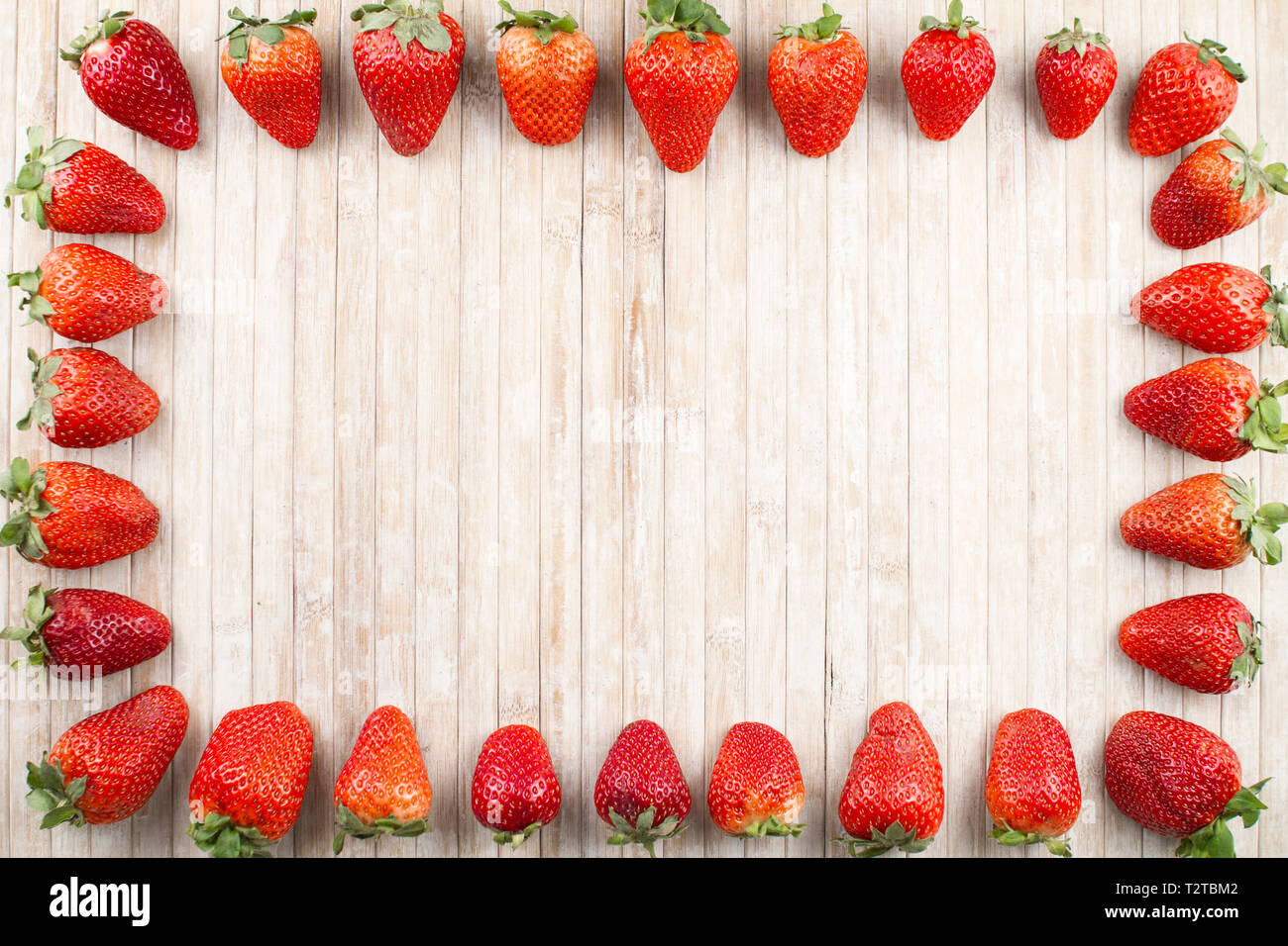 Strawberries copy space with strawberries all along the perimeter to ...