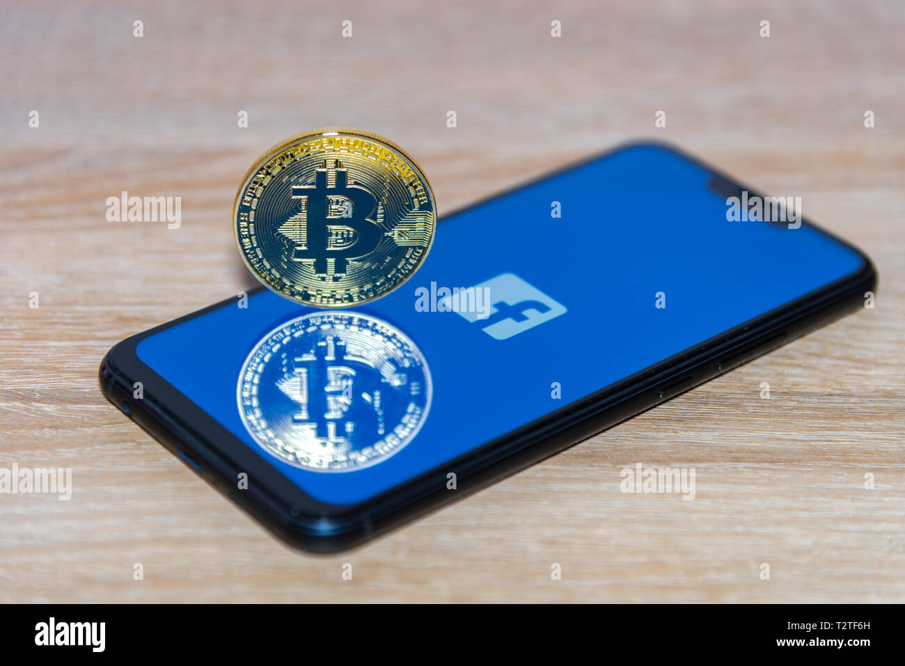 Bitcoin coin with the Facebook logo on a smartphone screen Stock Photo ...