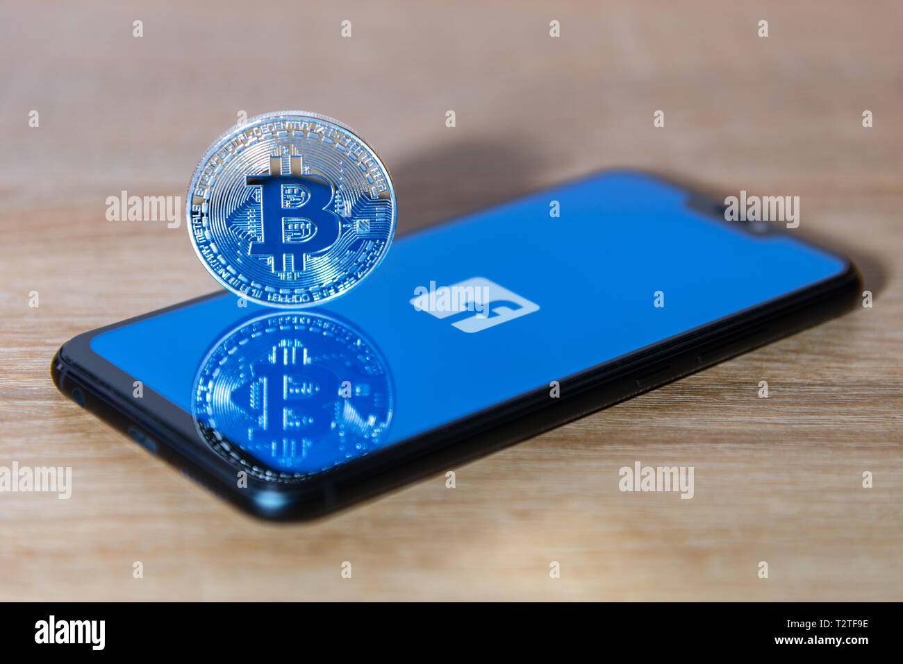 Bitcoin coin with the Facebook logo on a smartphone screen Stock Photo ...