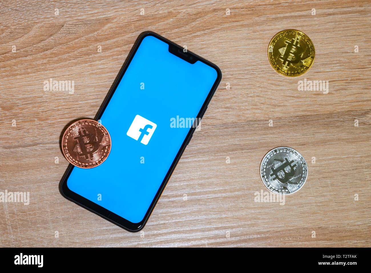 Bitcoin coin with the Facebook logo on a smartphone screen Stock Photo ...