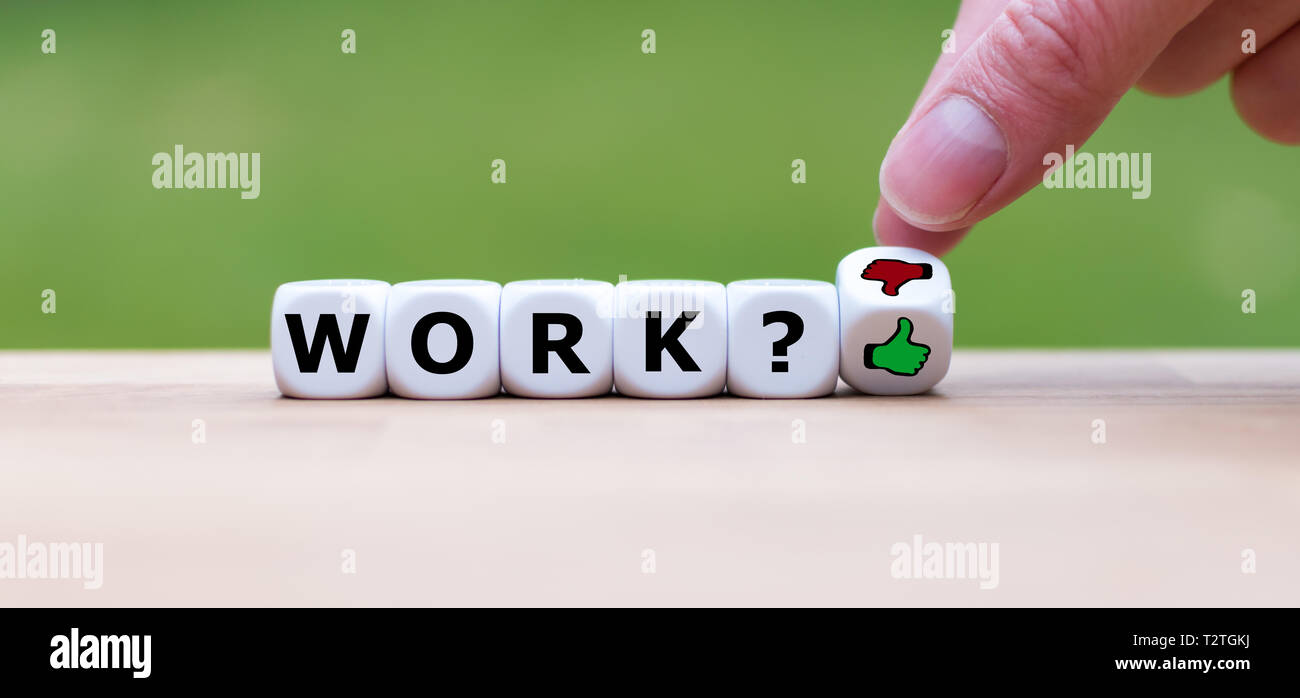 Symbol about job satisfaction. Dice form the word "work" and a hand ...