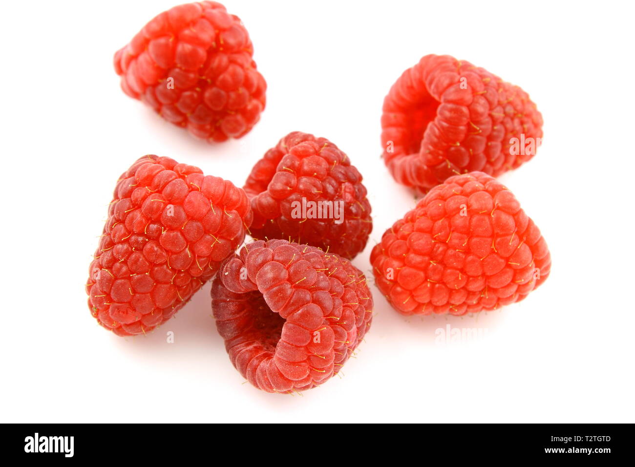 composition of fresh red raspberry fruits isolated on a white ...