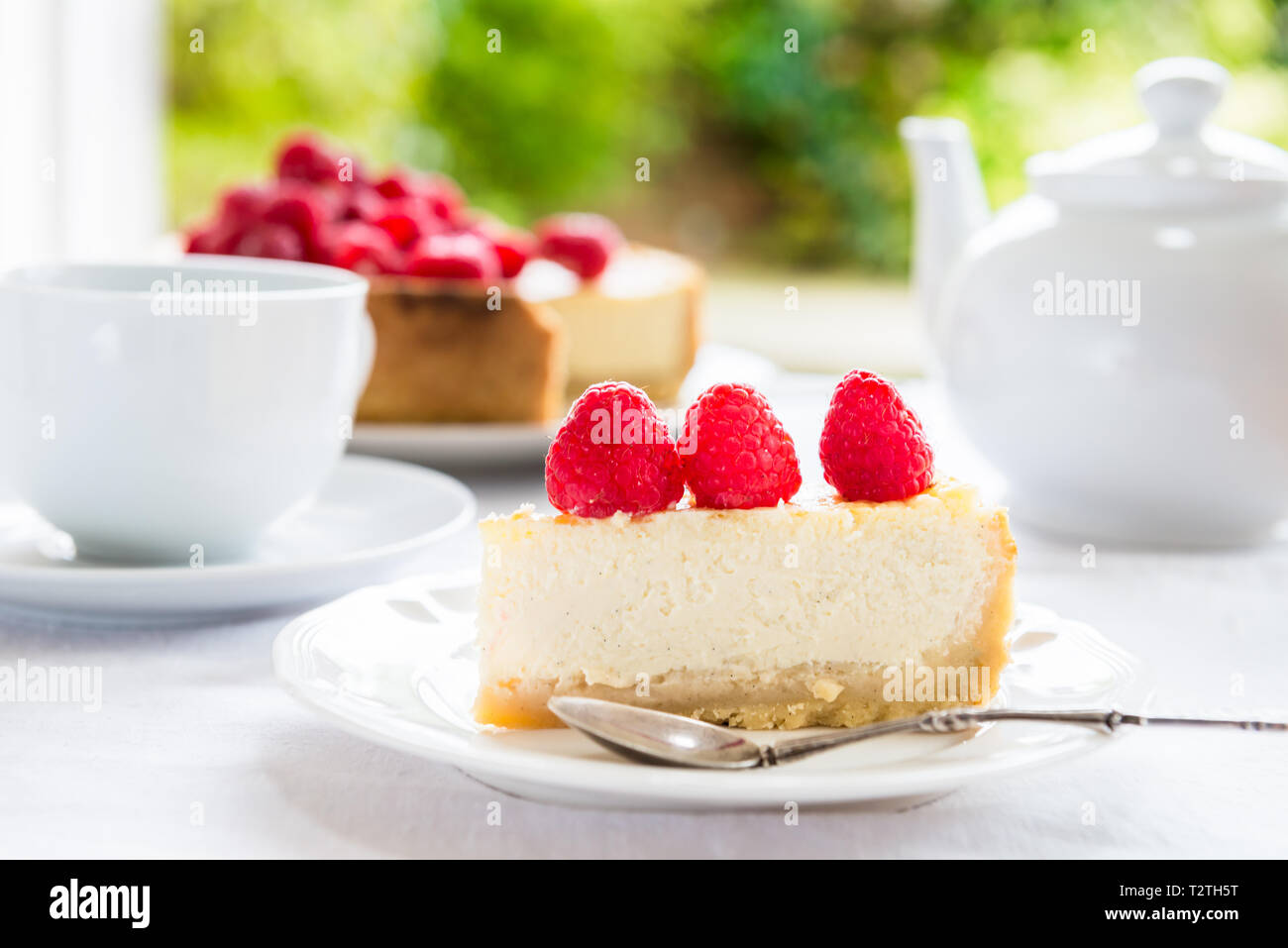 Slice of Homemade Vanilla Cheesecake with Raspberries on Summer Light ...