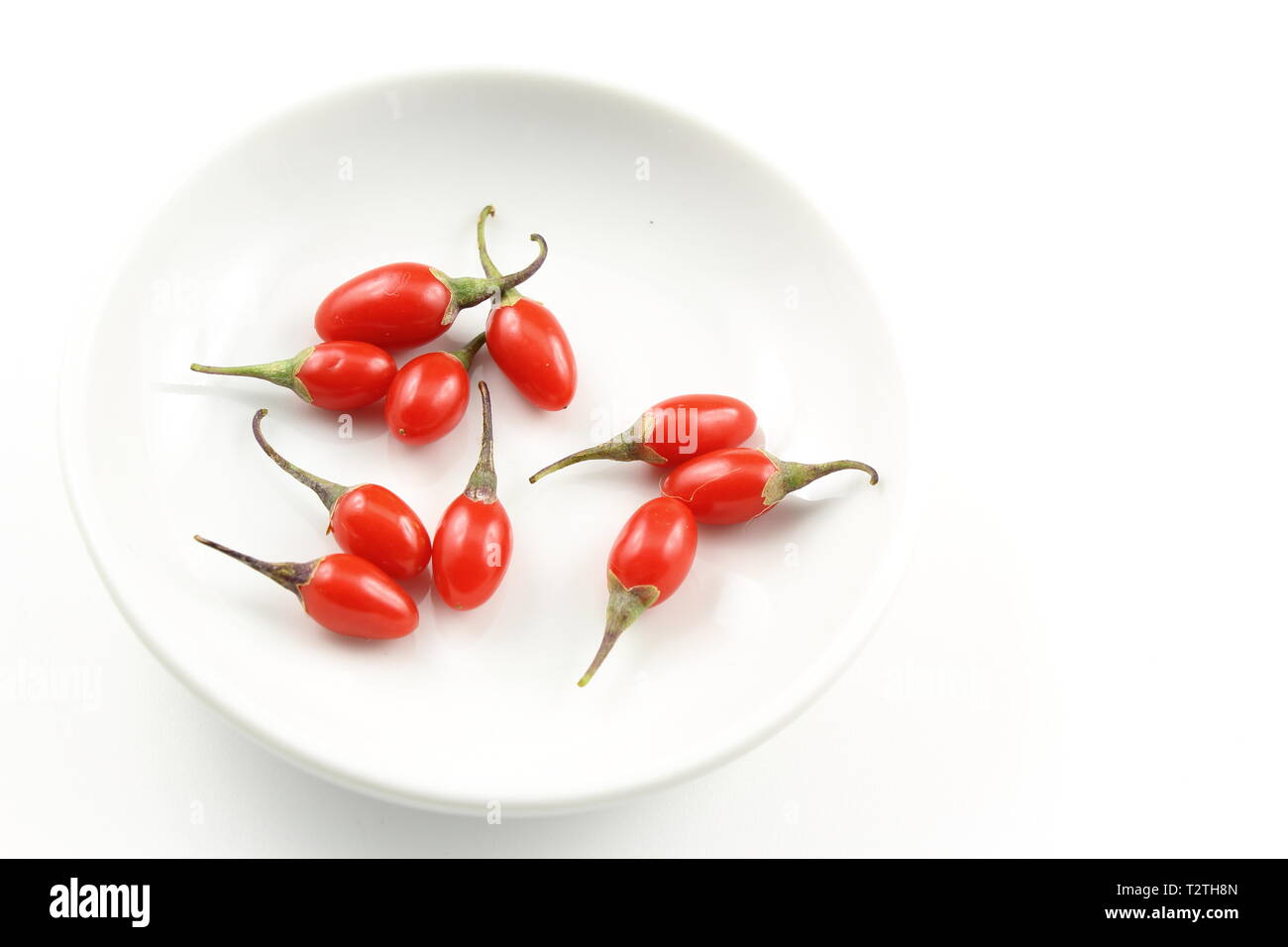 fresh goji berries in a small white bowl isolated on a white background ...