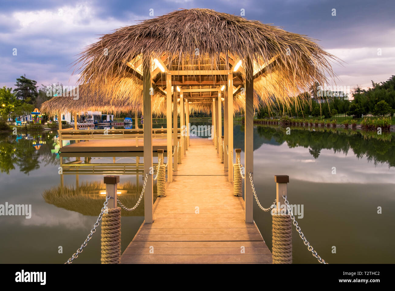 Pavilion straw thatch bridge way middle lake at evening Stock Photo - Alamy