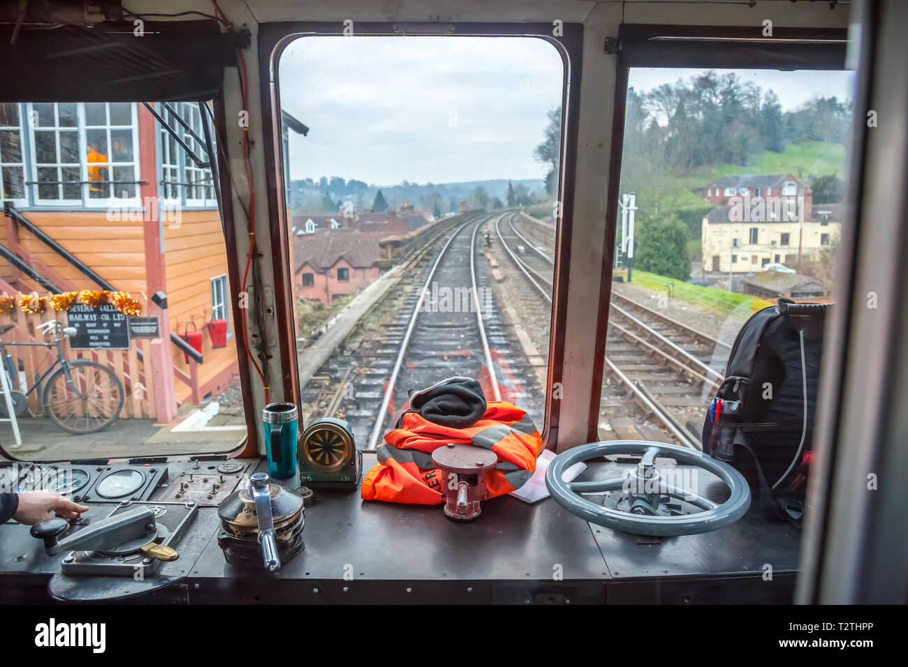 At the controls, in the driving seat. Train driver view through front ...