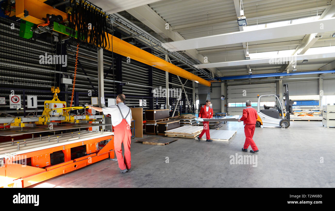employees in a metalworking company - interior with machines in the ...