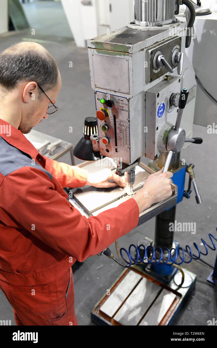 operator of a drilling machine in a industrieal company Stock Photo - Alamy