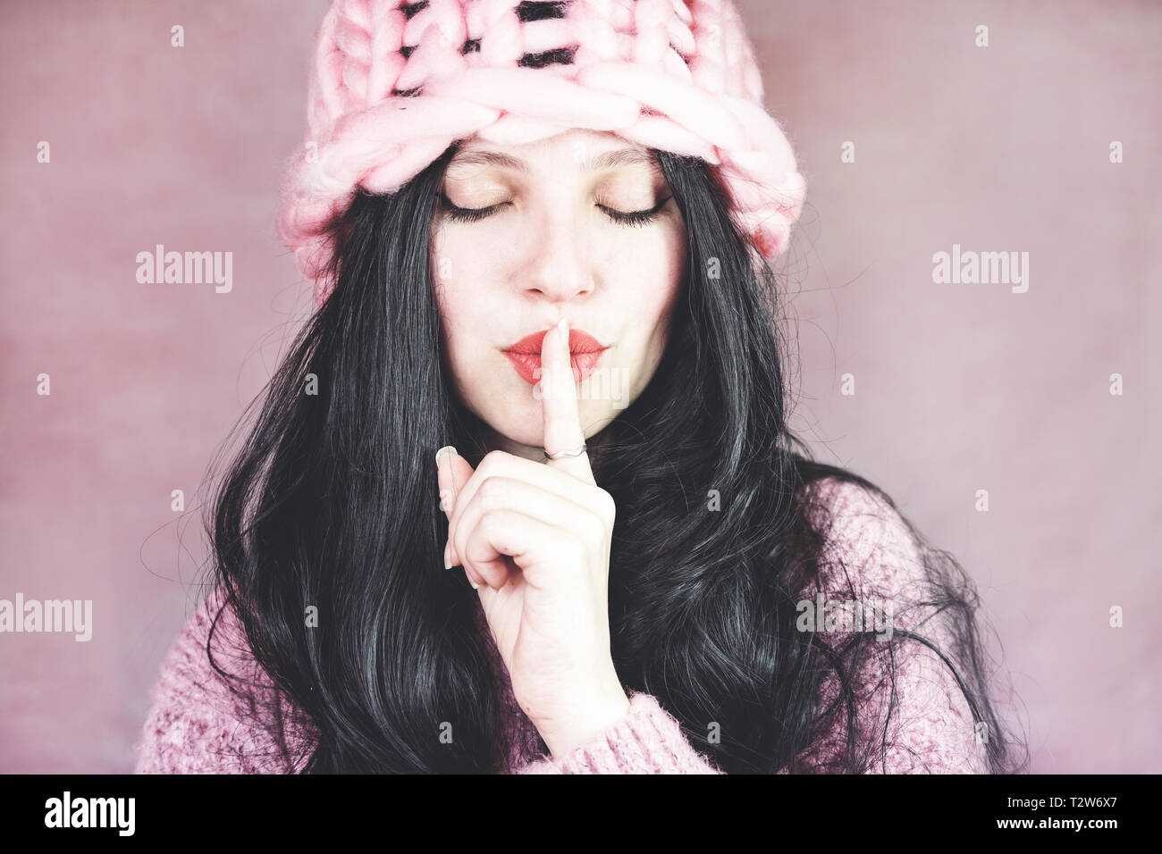Beautiful brunette women doing silent gesture Stock Photo - Alamy