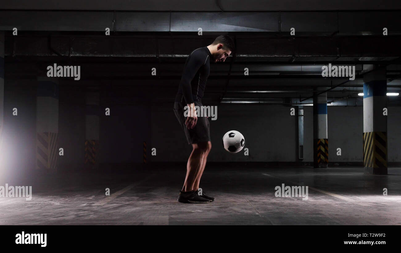 A soccer man training the basic tricks with the ball. Mid shot Stock ...