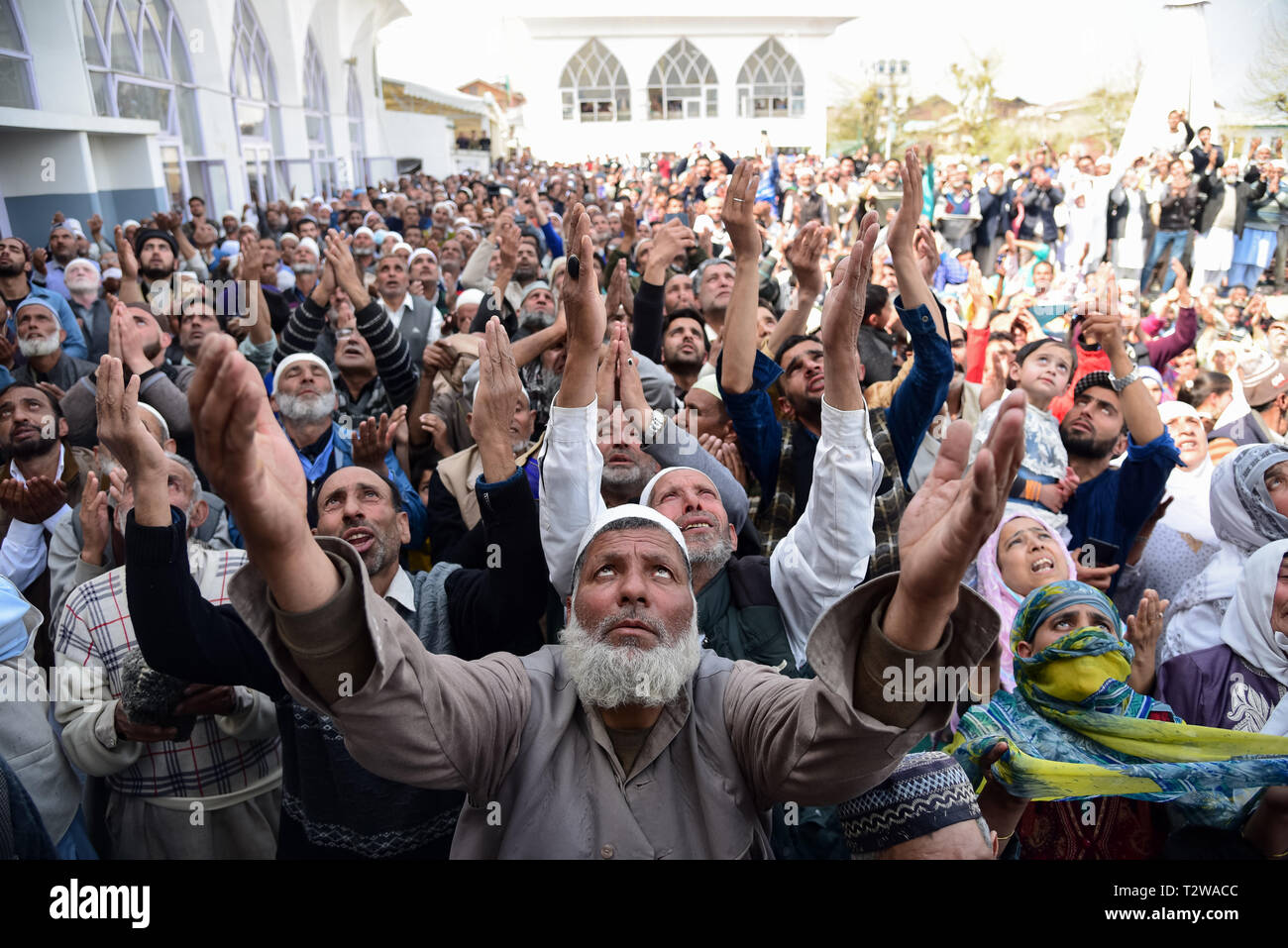 Kashmiri Muslim devotees seen raising their hands while beseeching for ...