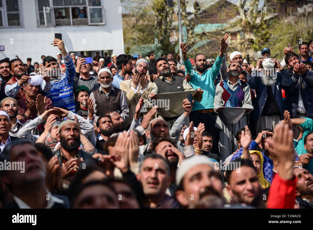 Kashmiri Muslim devotees seen raising their hands while beseeching for ...