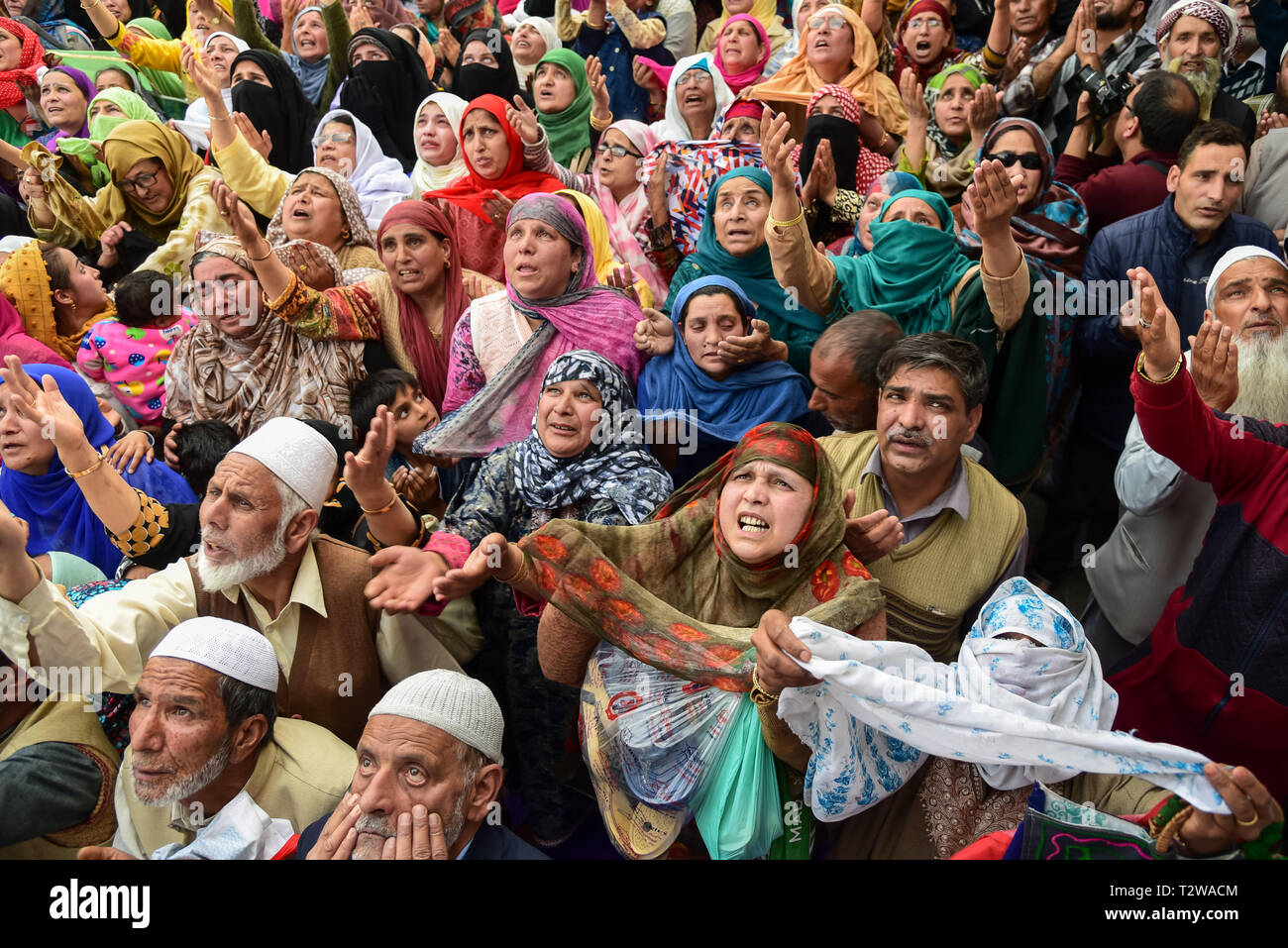 Kashmiri Muslim devotees seen raising their hands while beseeching for ...
