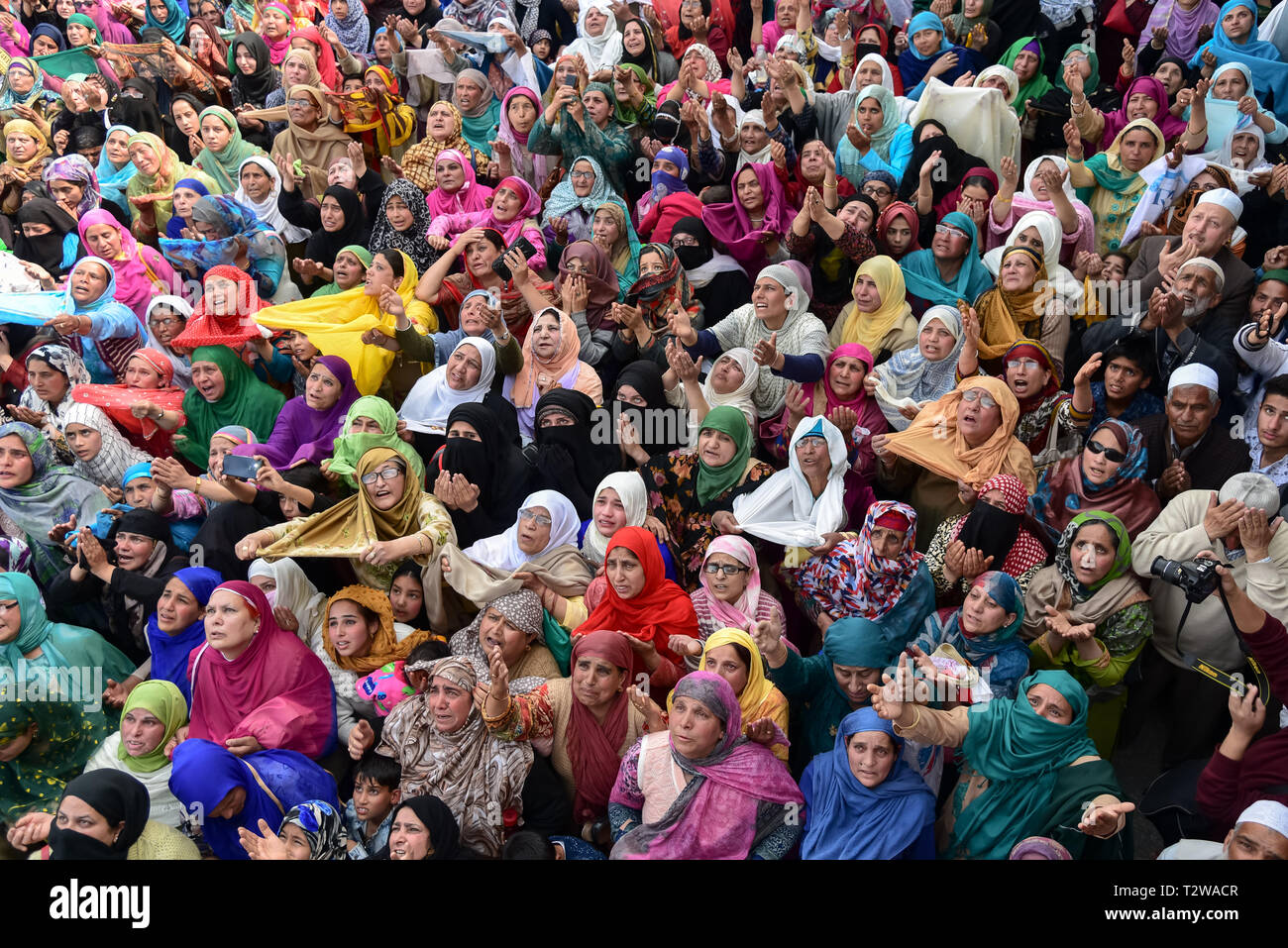 Kashmiri Muslim devotees seen raising their hands while beseeching for ...