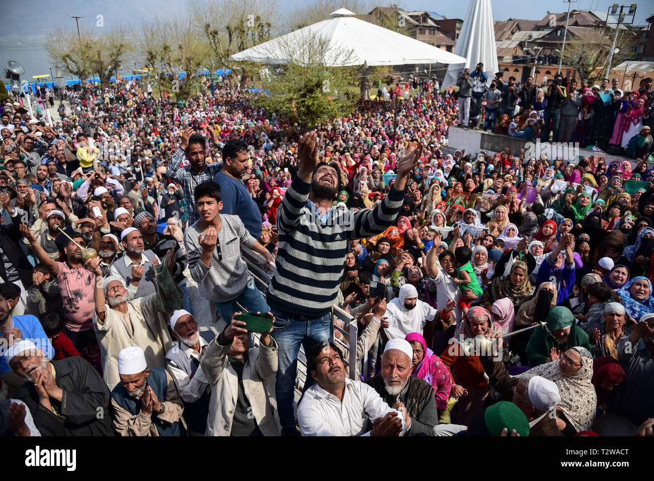 Kashmiri Muslim devotees seen raising their hands while beseeching for ...