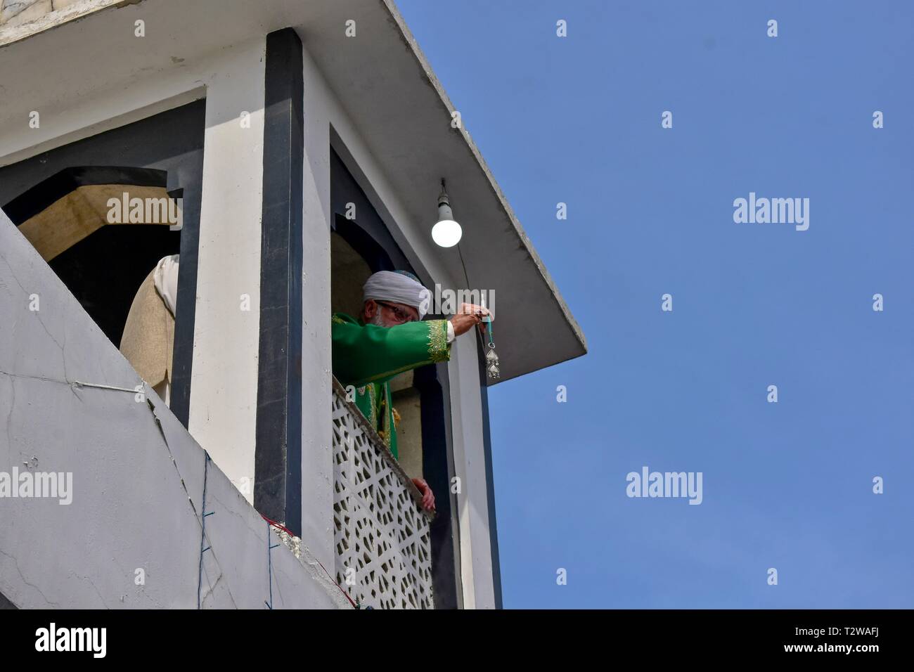 A head priest seen displaying a relic of the Prophet Muhammad during ...