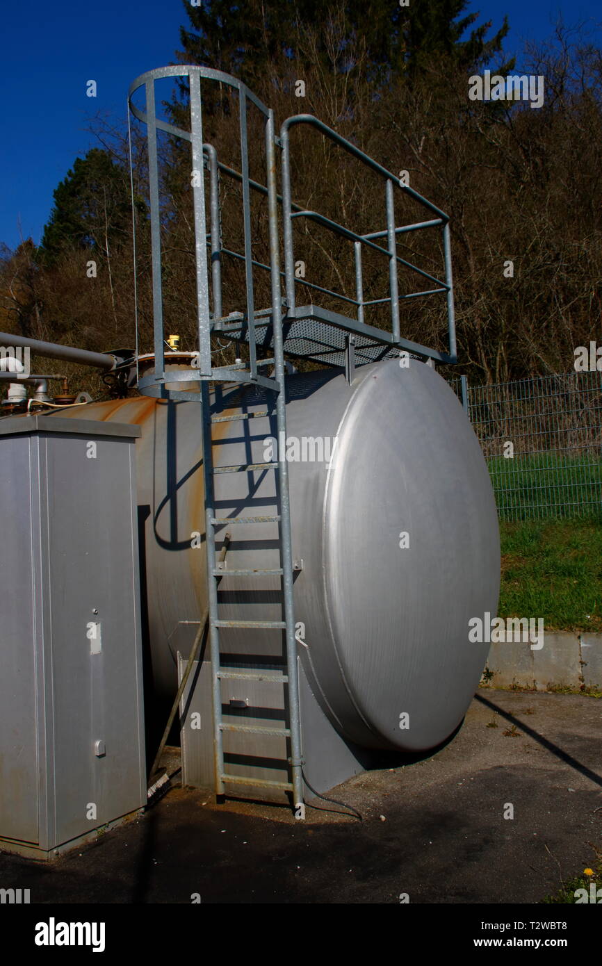 Ladder with safety bar for safe ascent to a storage tank Stock Photo ...