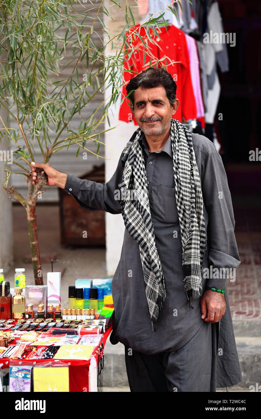 Pakistani salesman in shalwar-kameez attire at the Sunday Market-city's ...