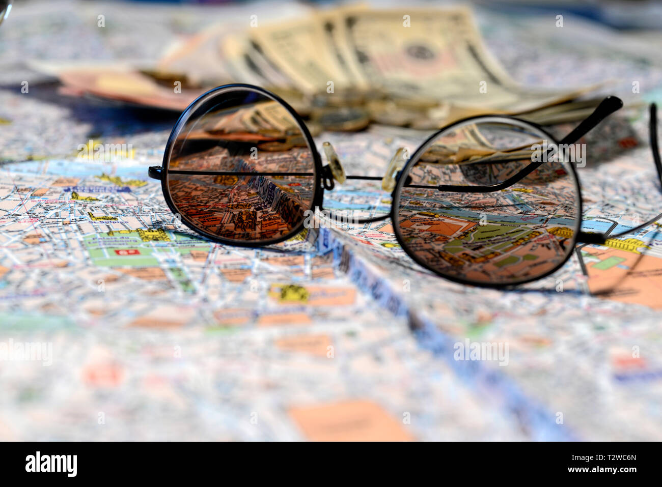 Sunglasses and money on a tourist map background. Tourism concept Stock ...
