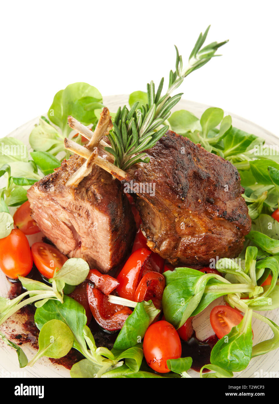 Rare fried rack of lamb isolated on white background, close-up shot ...