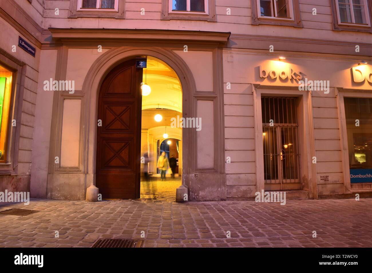 Alleyway gate and bookstore in Domgasse, a narrow cobblestone street ...