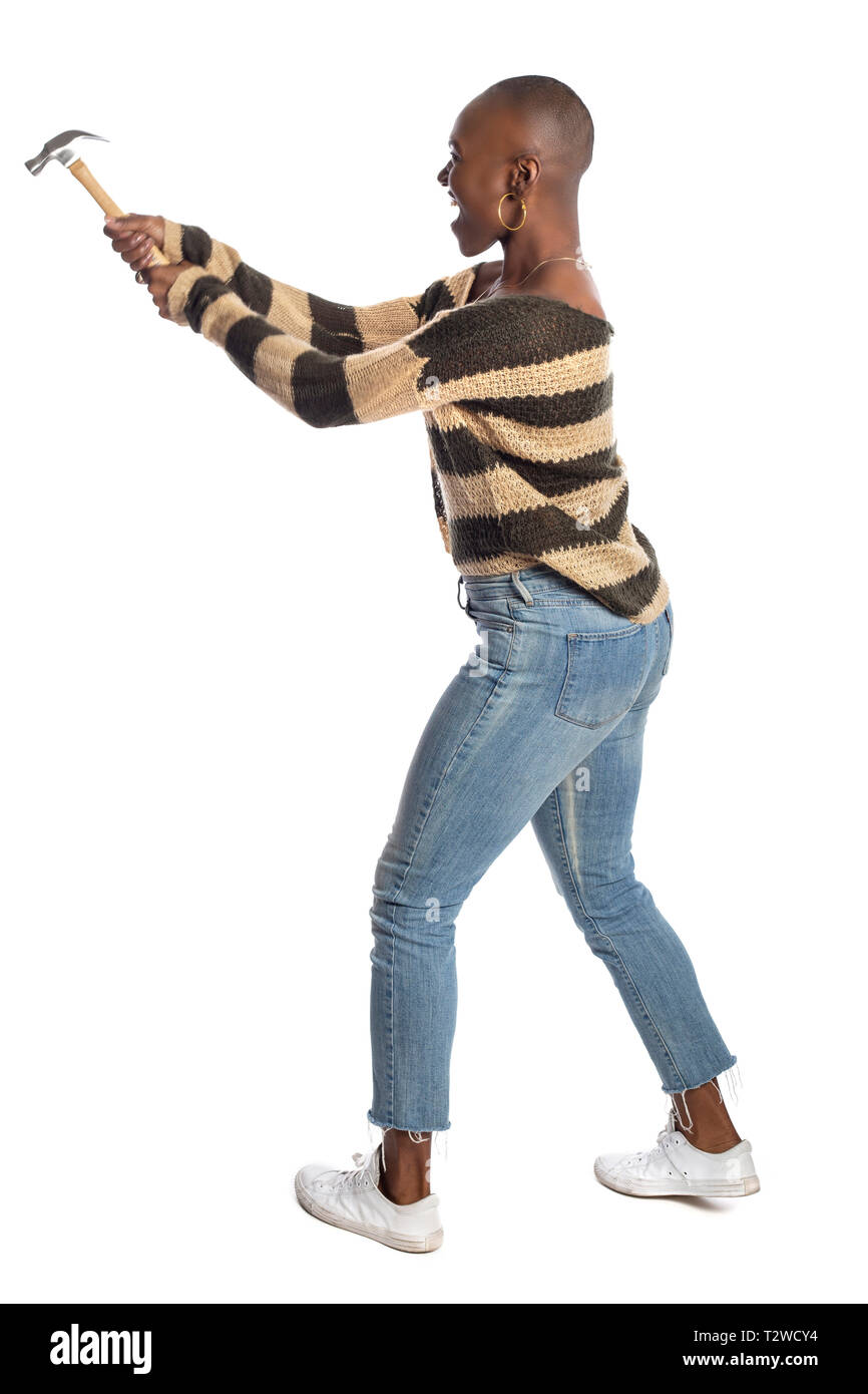 Black African American female swinging a hammer pretending to hit or ...