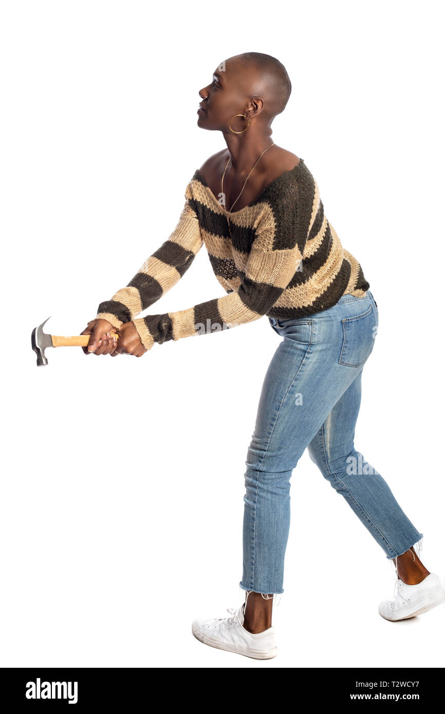 Black African American female swinging a hammer pretending to hit or ...