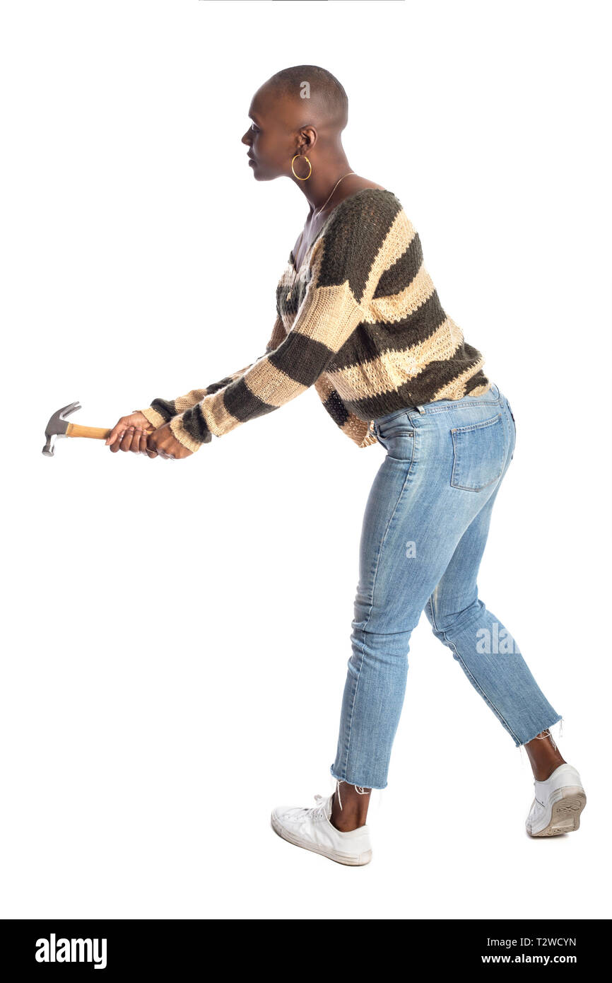 Black African American female swinging a hammer pretending to hit or ...