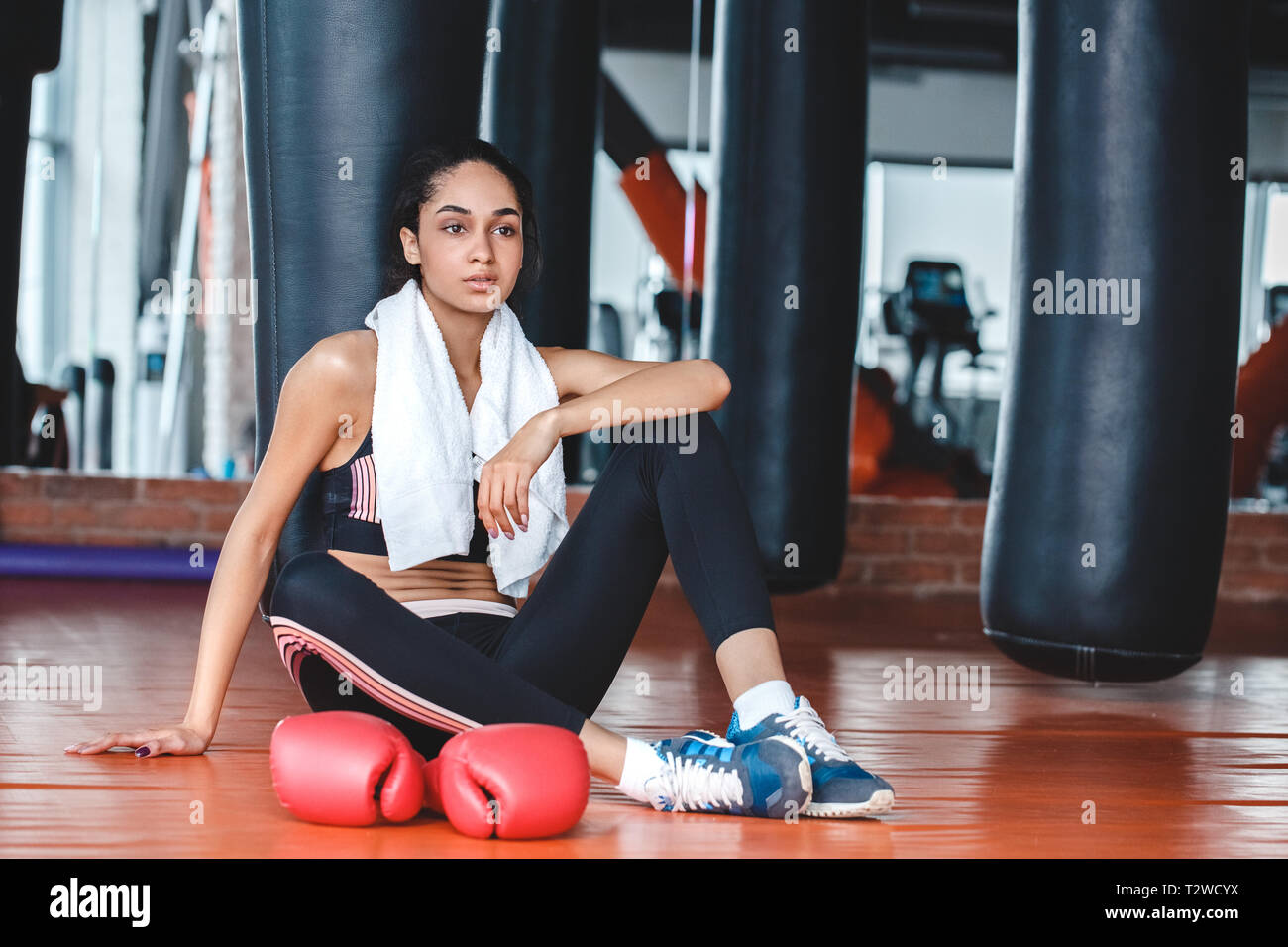 Young girl wearing towel in gym sporty lifestyle concept sitting on ...