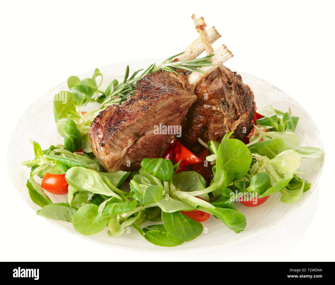 Rare fried rack of lamb isolated on white background Stock Photo - Alamy