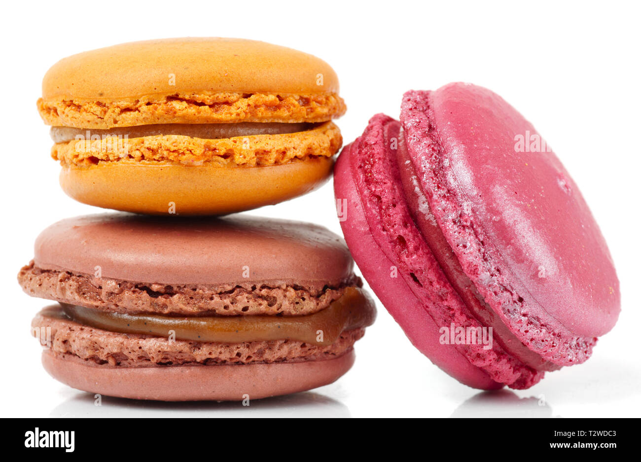 Three colorful macarons isolated on white background Stock Photo - Alamy