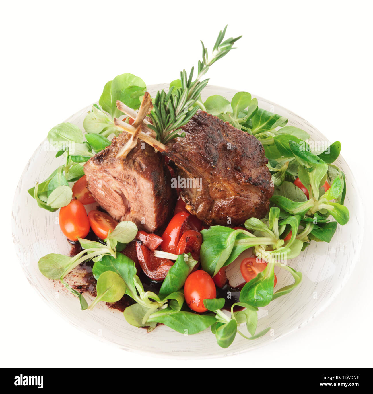 Rare fried rack of lamb isolated on white background Stock Photo - Alamy