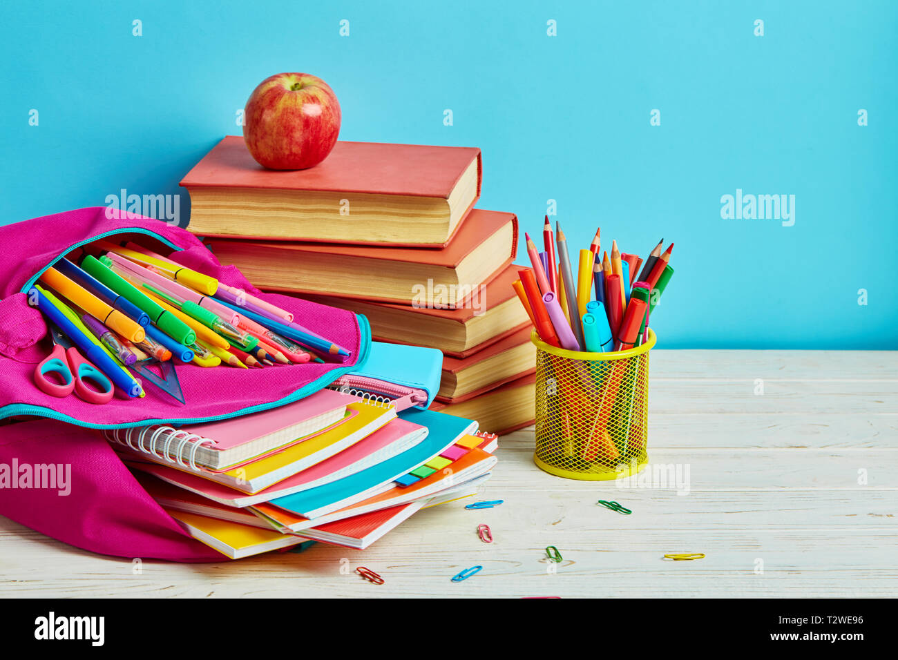 Working mess on the table in the student. School and office supplies ...