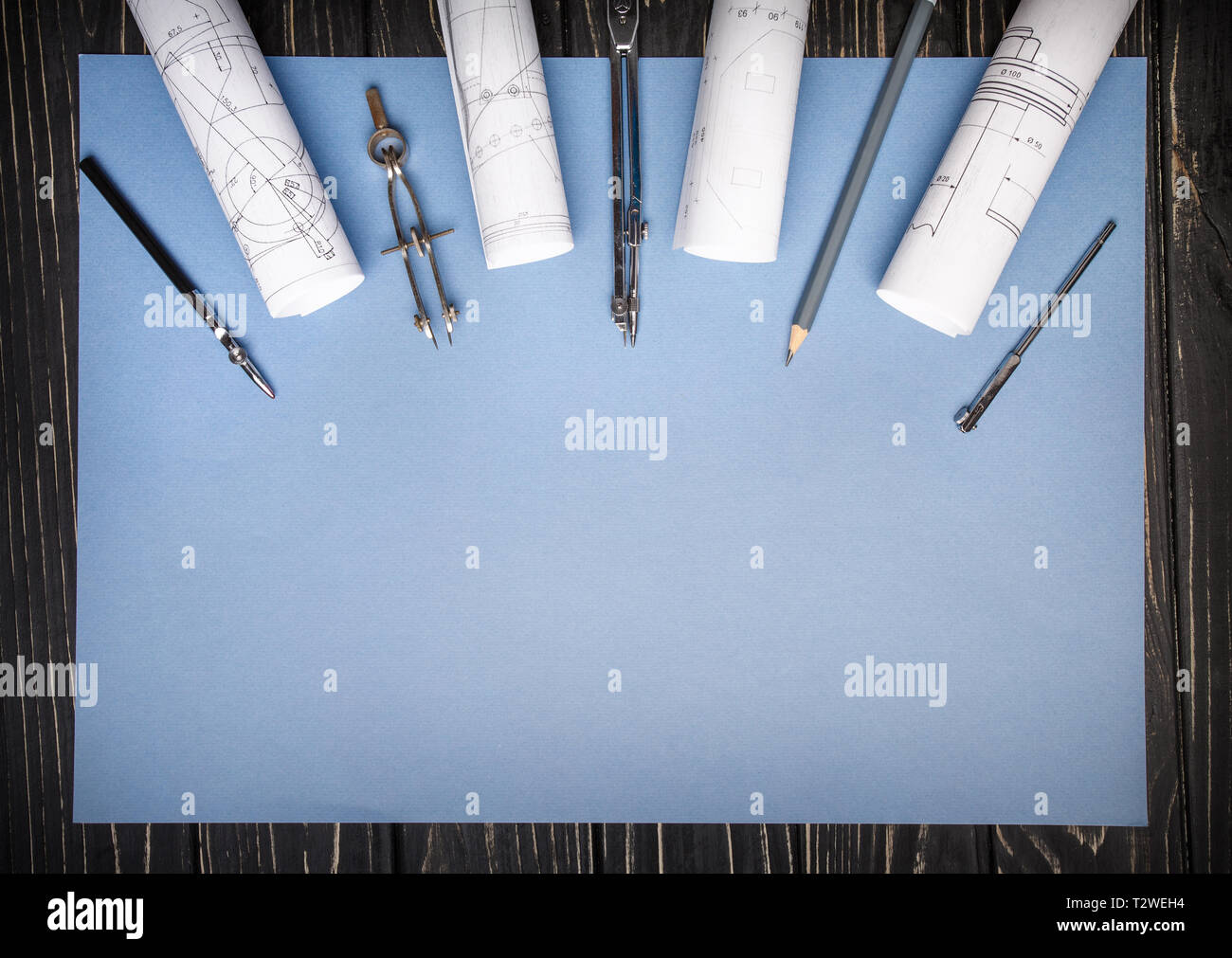 Compasses, rulers from the drawing and a pencil on a blue background ...