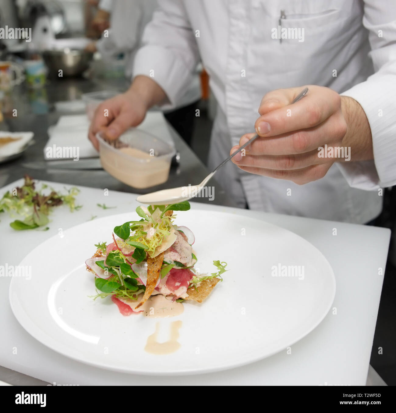 Chef is cooking fish appetizer on professional kitchen Stock Photo - Alamy