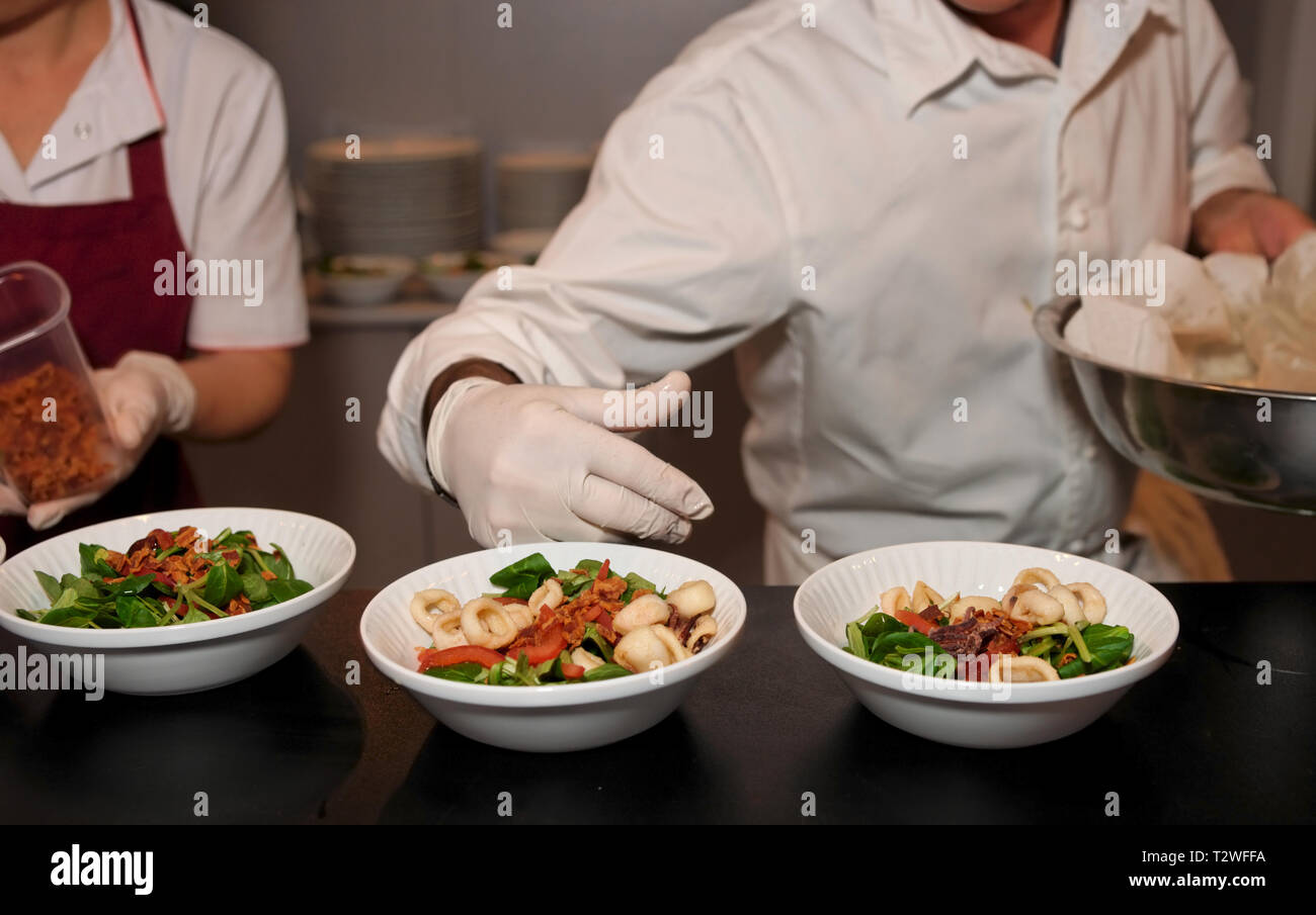 Chef is serving plates in open kitchen Stock Photo - Alamy