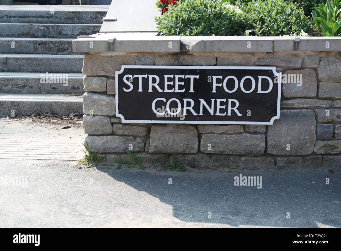 Street Food Corner sign on stonewall Stock Photo - Alamy