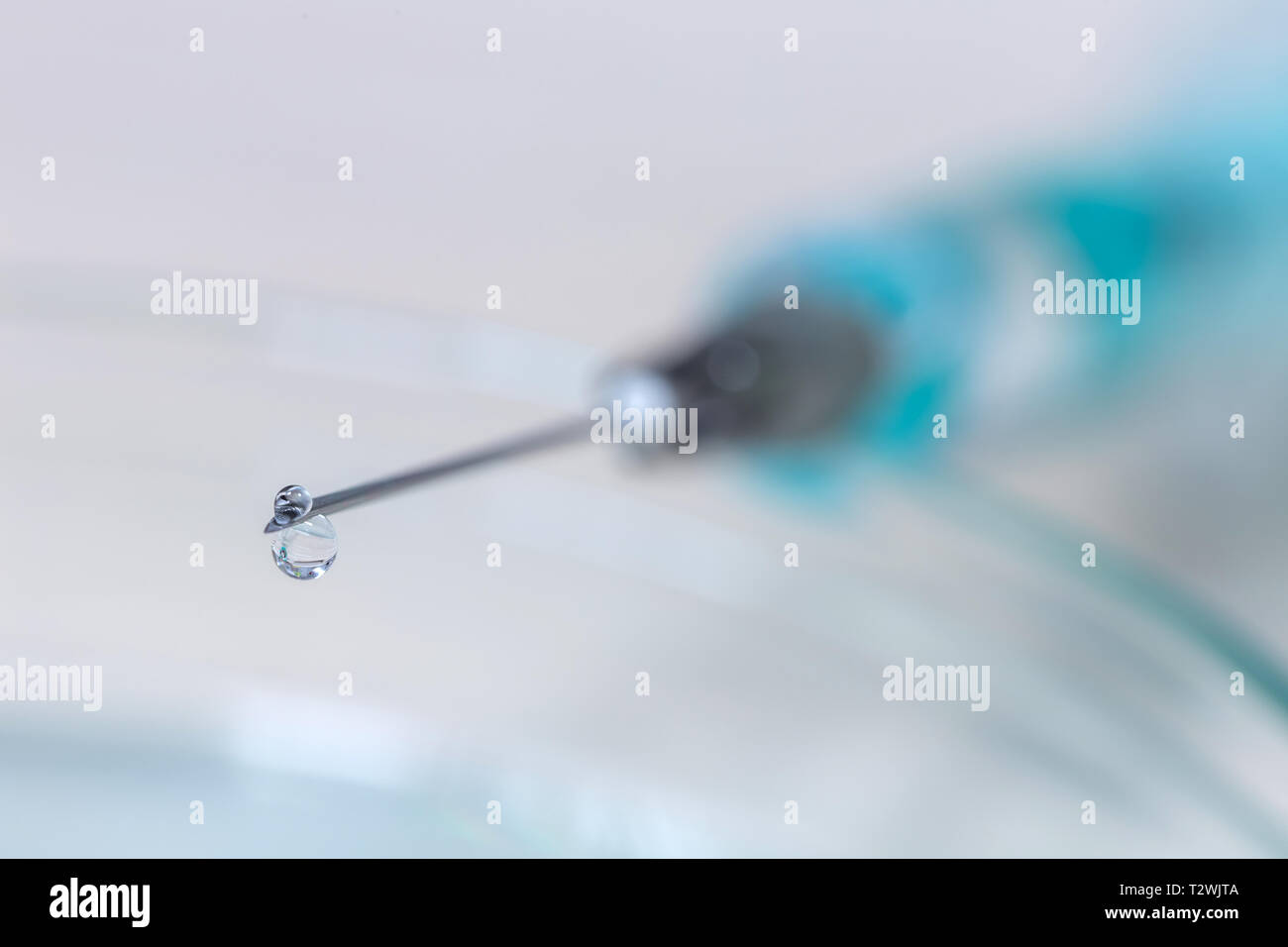 syringe with medical fluid drop background Stock Photo - Alamy