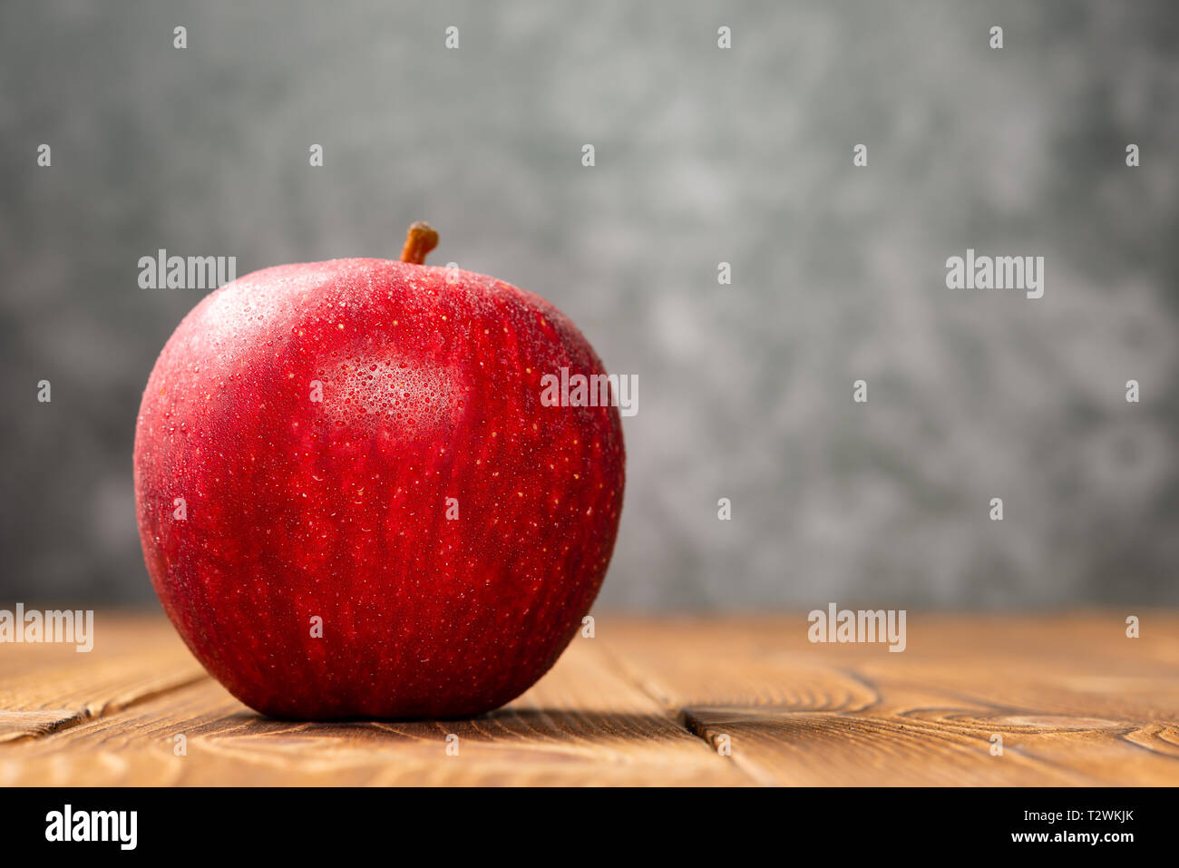 fresh apple with drips stops on a wood table with copy space Stock ...